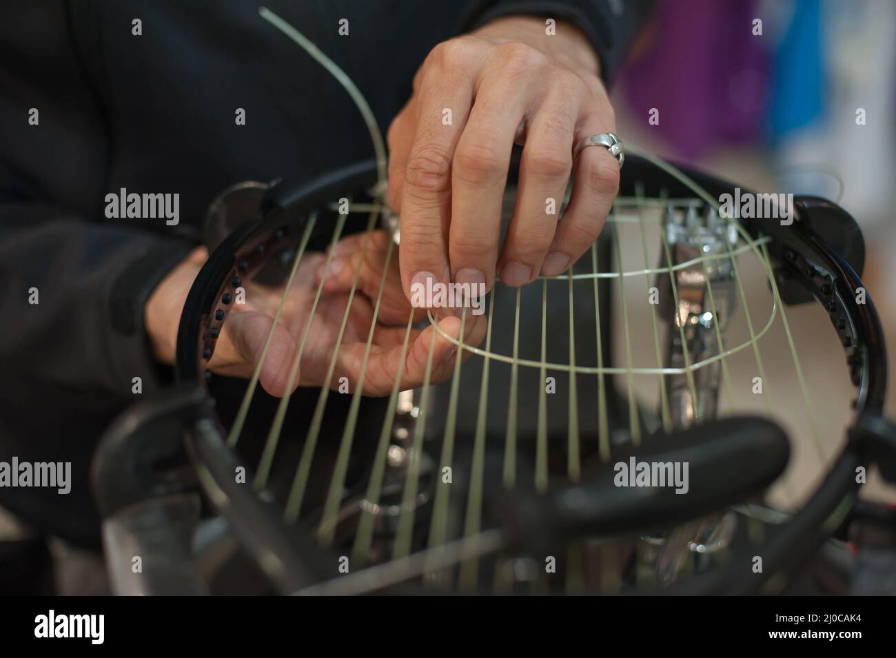 Stringing Machine. Close up of tennis stringer hands doing racket ...