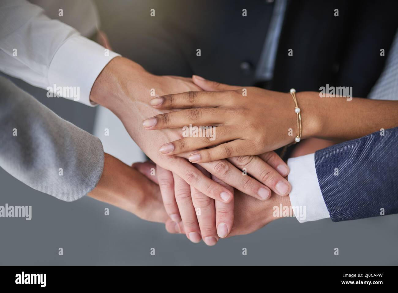Go all in, get it done. Cropped shot of a group of colleagues joining ...