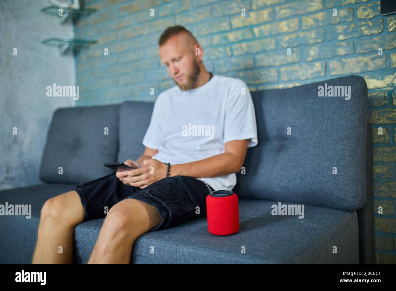 Male testing talking smart wireless speaker, man controlling home ...