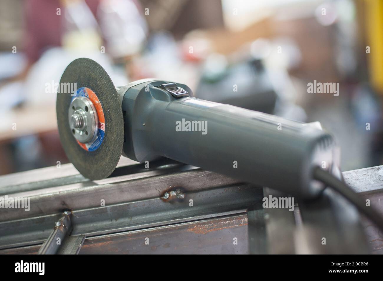 Electric wheel grinding on steel structure in factory. Close up Stock ...