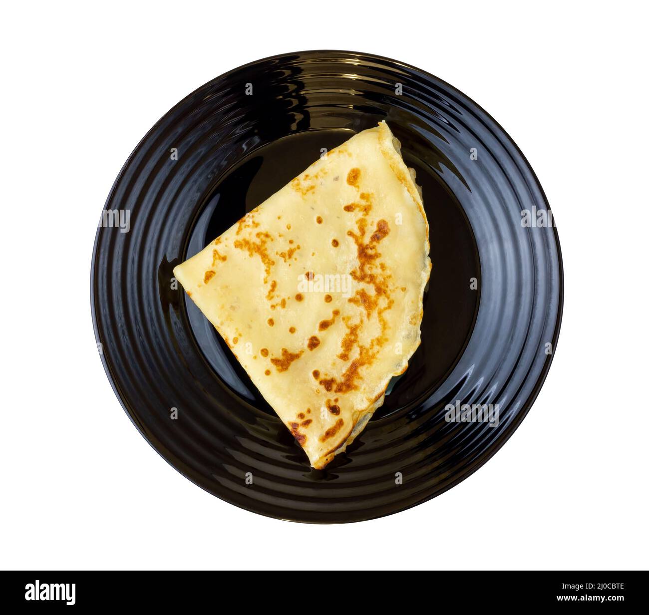 Pancake on a black plate. View from above. Isolate on a white ...