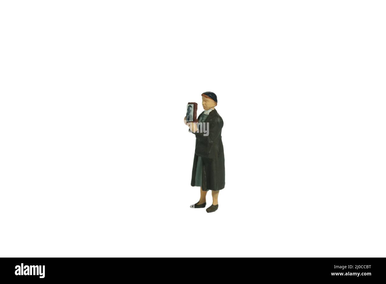 Miniature people toy figure photography. A woman holding photo frame ...