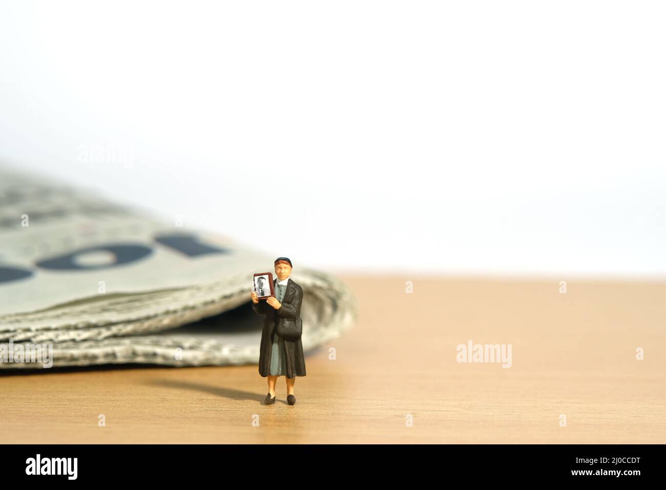 Miniature people toy figure photography. A woman holding photo frame ...