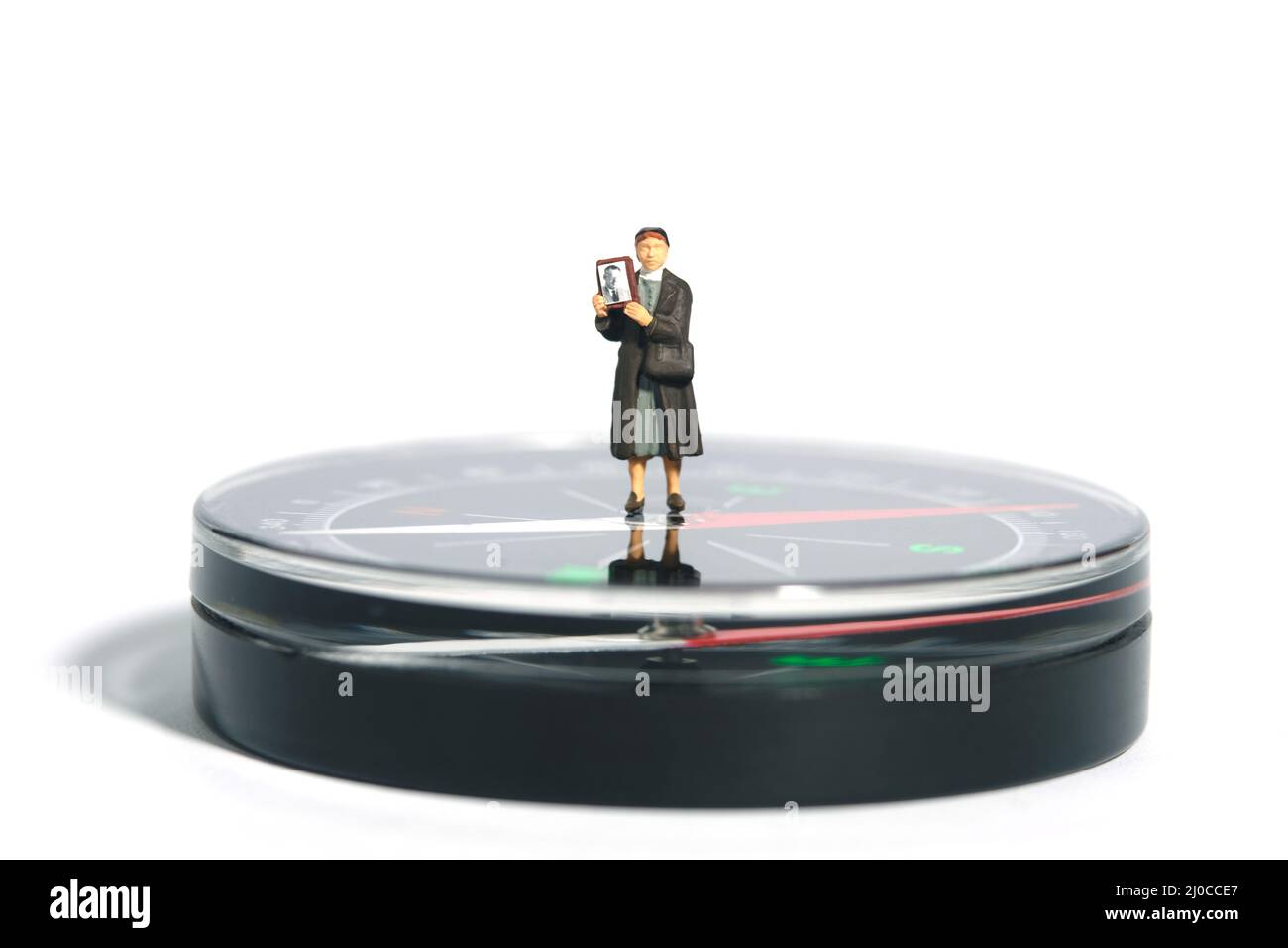 Miniature people toy figure photography. A woman holding photo frame ...