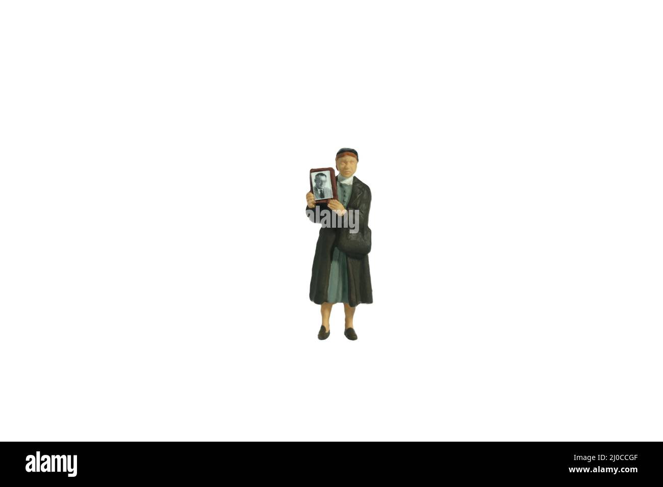 Miniature people toy figure photography. A woman holding photo frame ...