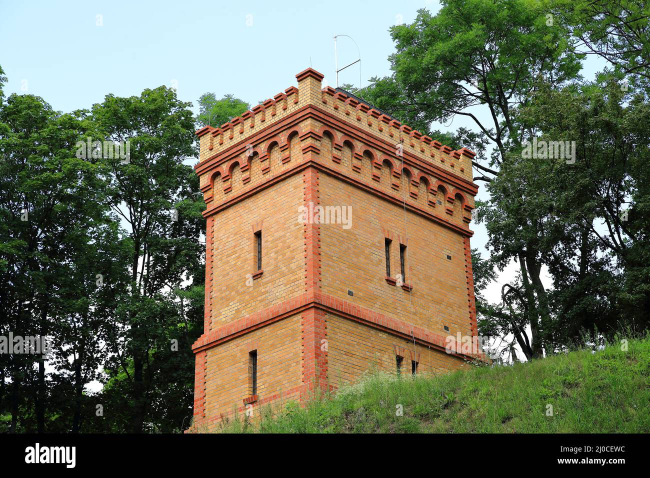 An old historic tower serving as a pumping station in the city park ...