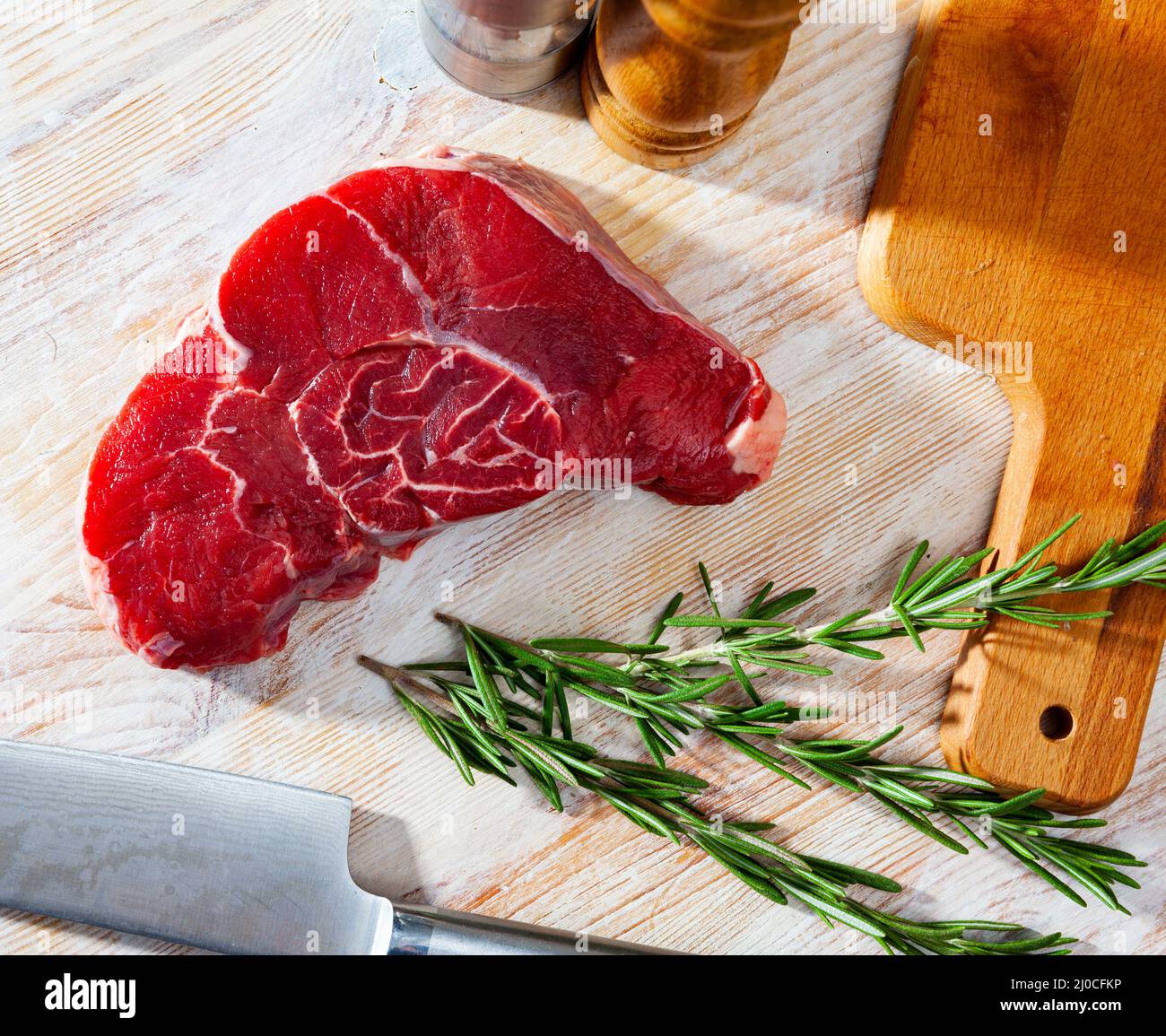 Raw boneless beef with rosemary Stock Photo - Alamy
