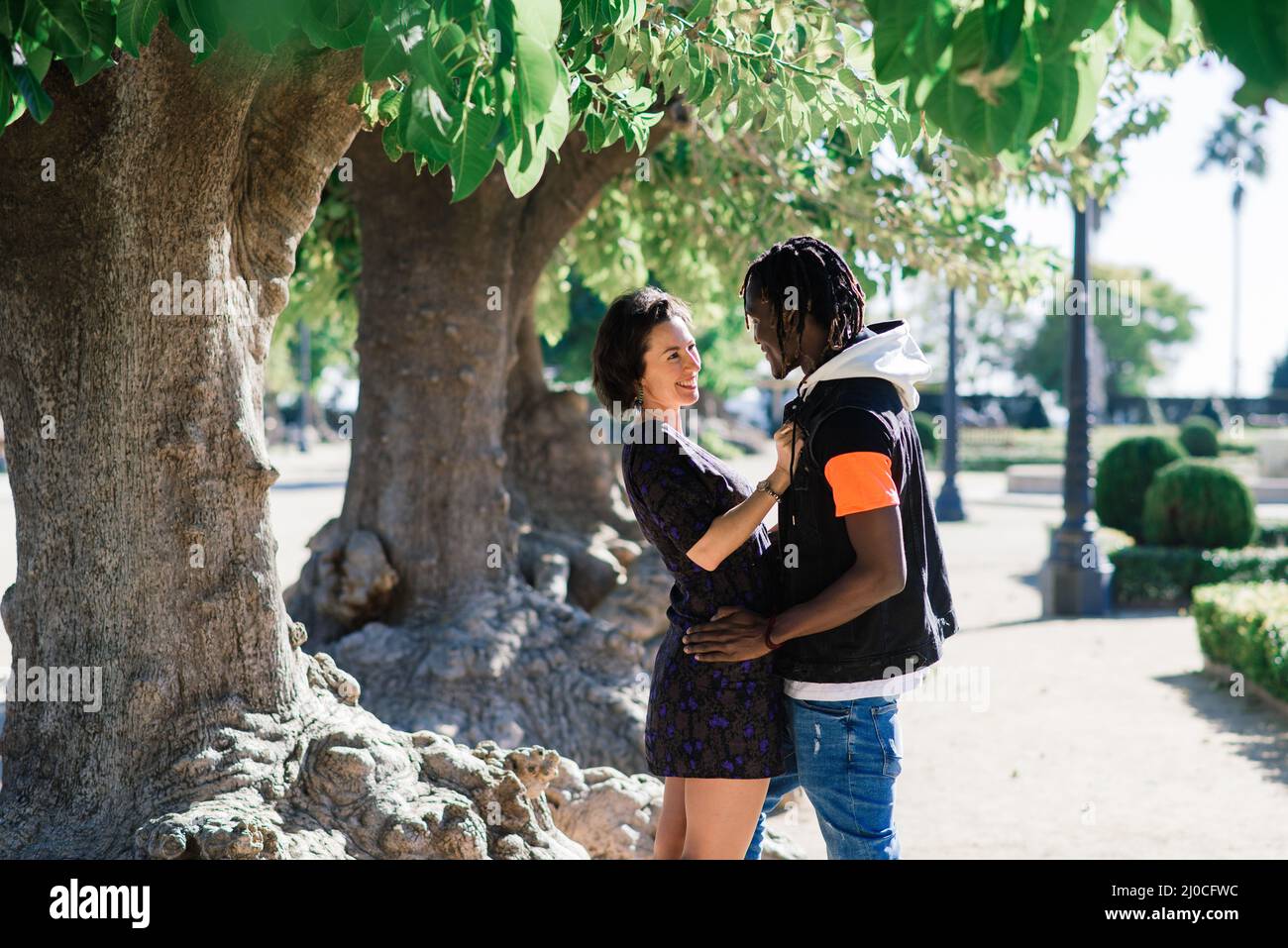 Two mixed race people. Handsome afro american guy standing with a ...