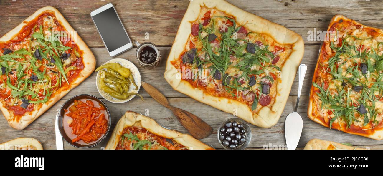 Appetizing homemade pizza on a wooden table.rustic style Friendly feast ...