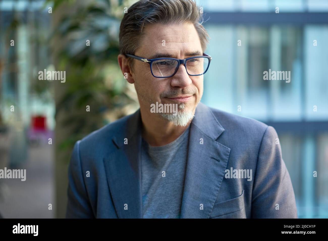 Middle aged confident businessman in business casual in office ...