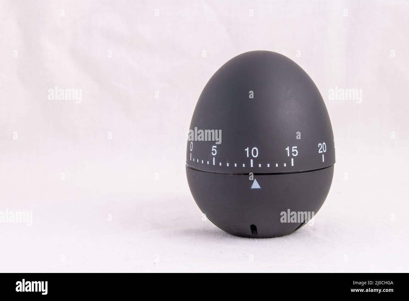 Closeup of the Kitchen timer shaped like and egg of black color on ...