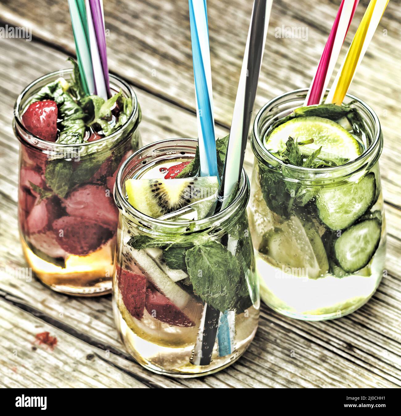 A variety of cold drinks in small bottles with pieces of fruit wooden ...