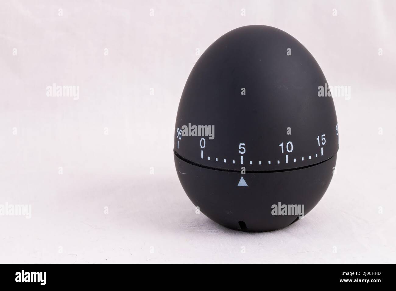 Closeup of the Kitchen timer shaped like and egg of black color on ...
