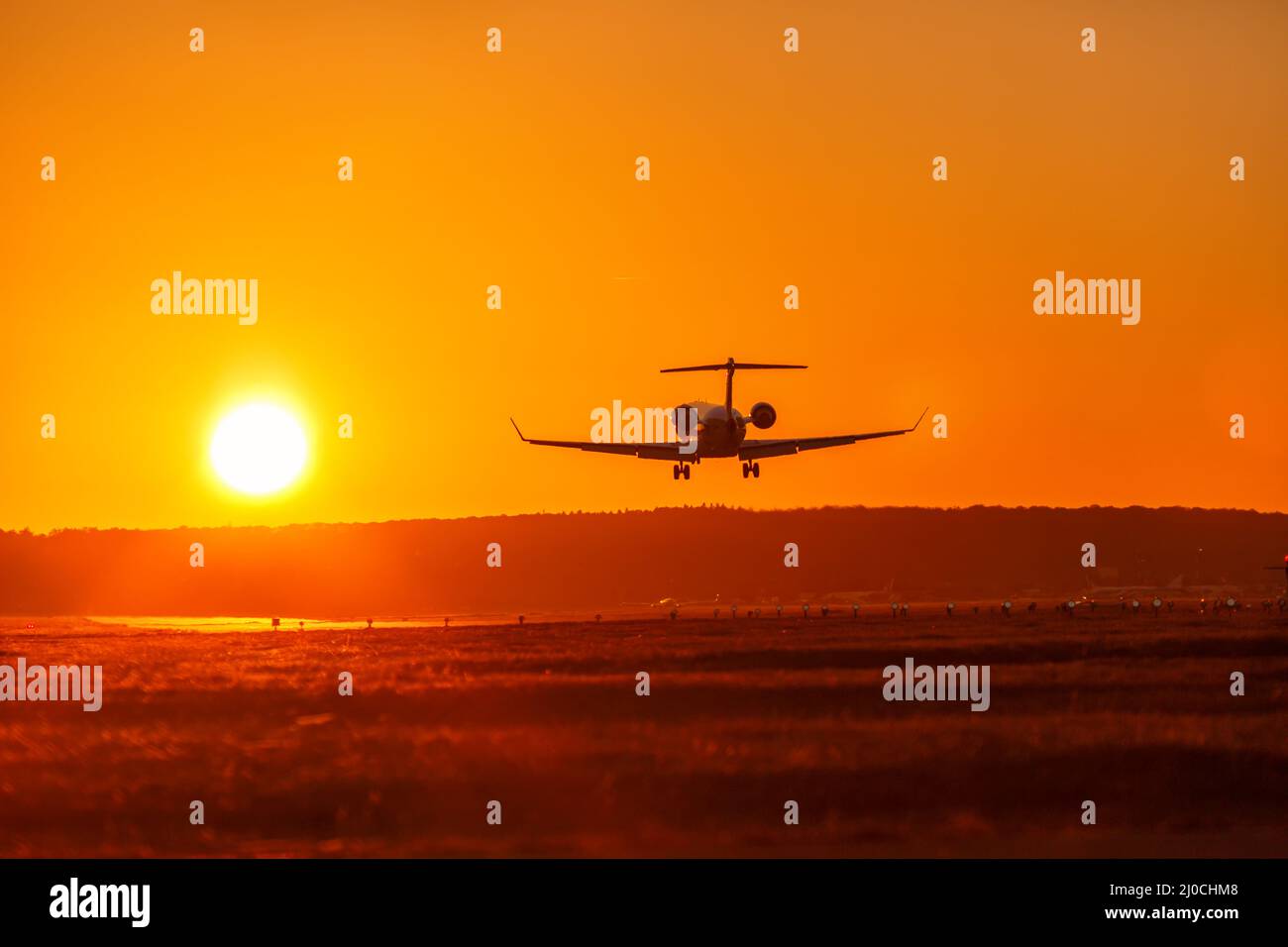 Airplane lands airport private jet sunset vacation travel Stock Photo ...