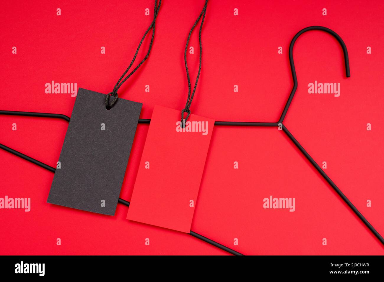 two empty, red and black labels lie on a bright background. Mockup for ...