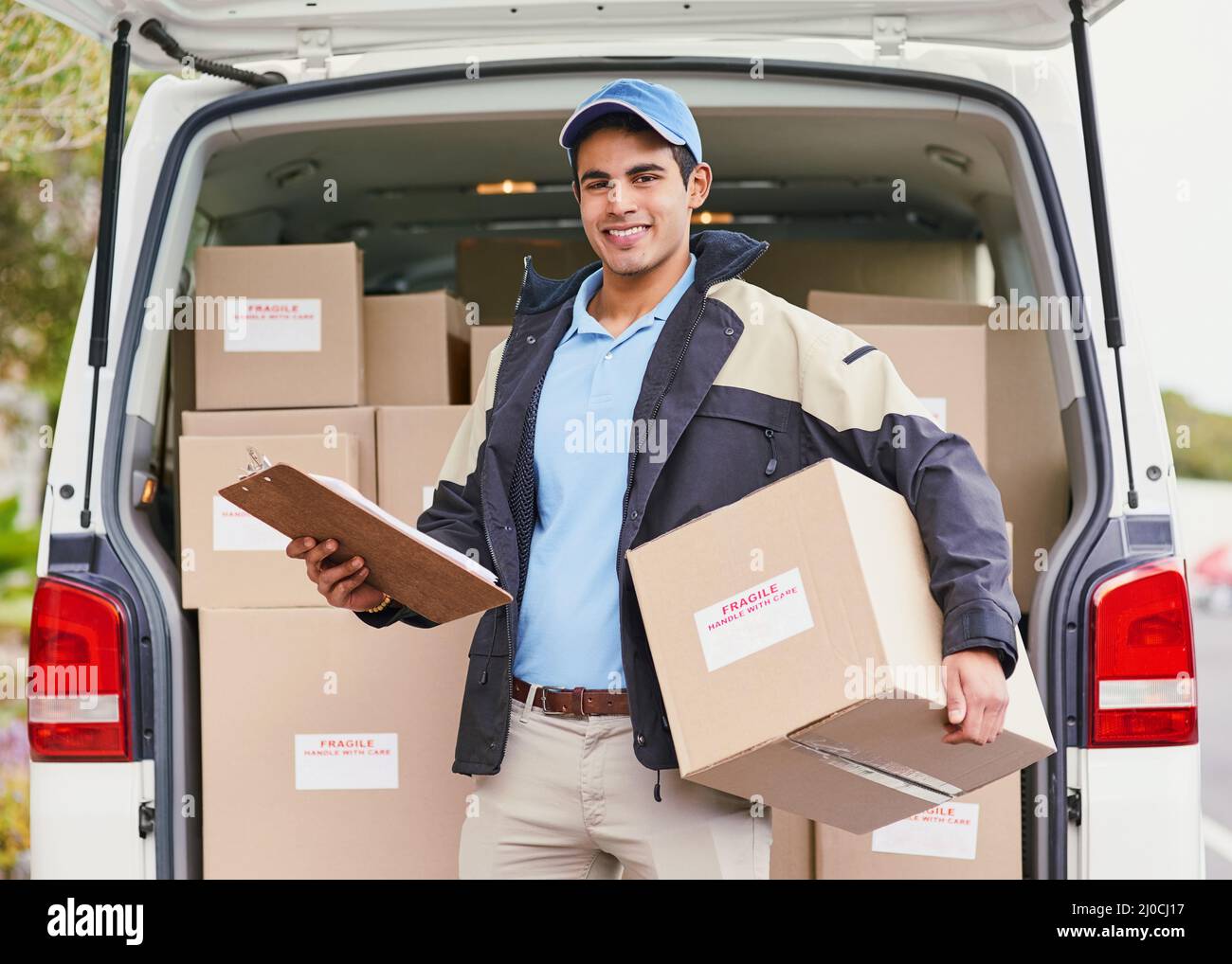 My deliveries are all running on schedule. Portrait of a delivery man ...