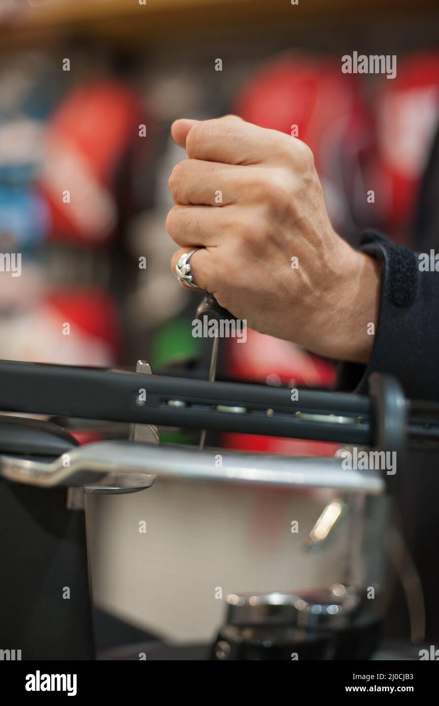 Stringing Machine. Detail of tennis stringer hands while holding awl ...
