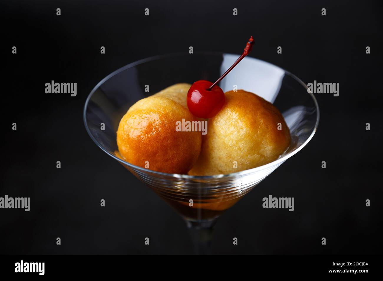 Neapolitan Rum baba (or baba au rum) in a martini glass with a cocktail ...