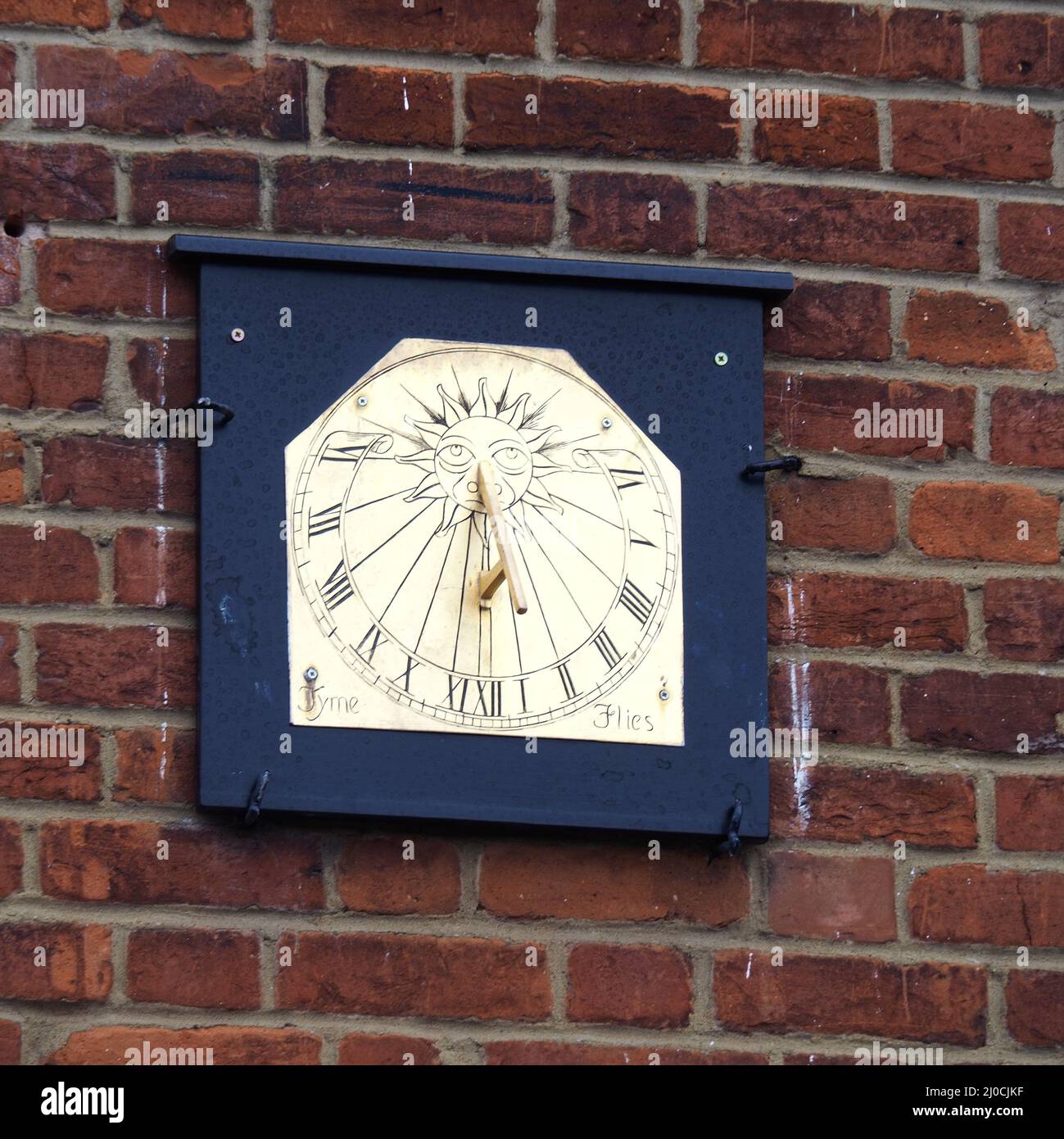 Sun Dial above door of Sun Dial House, Eton High Street, Eton Stock ...