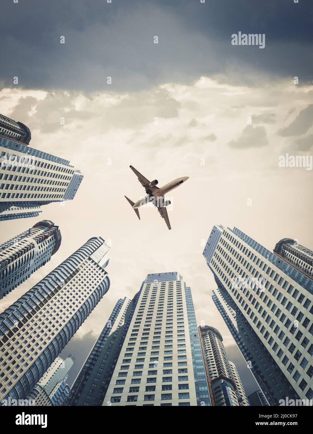 Plane encircled by buildings Stock Photo - Alamy