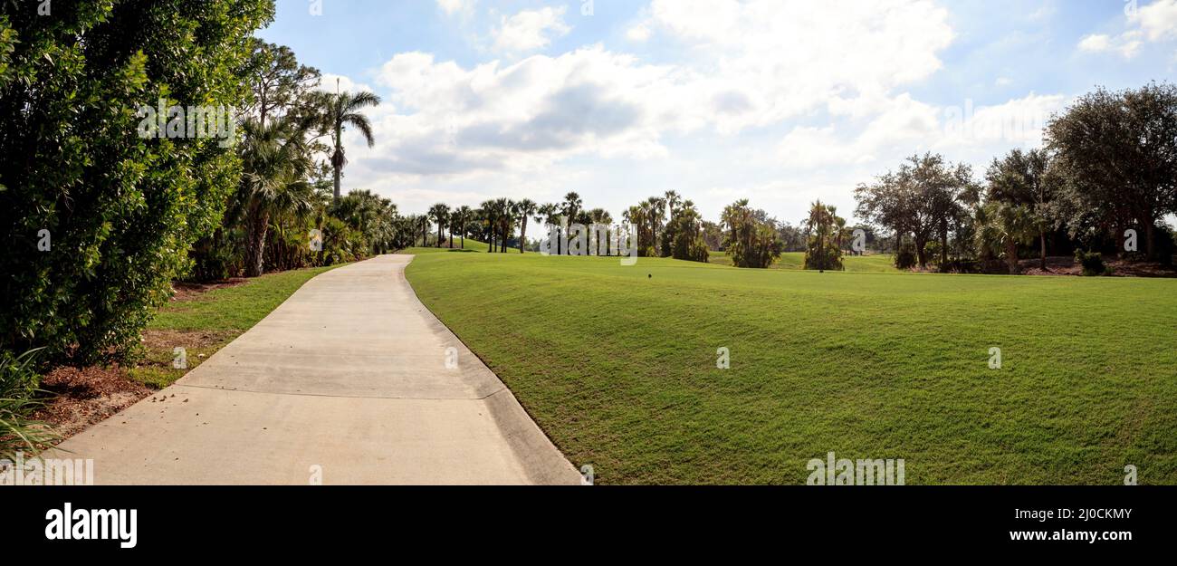 Lush green grass on a golf course with a path for a golf cart Stock ...