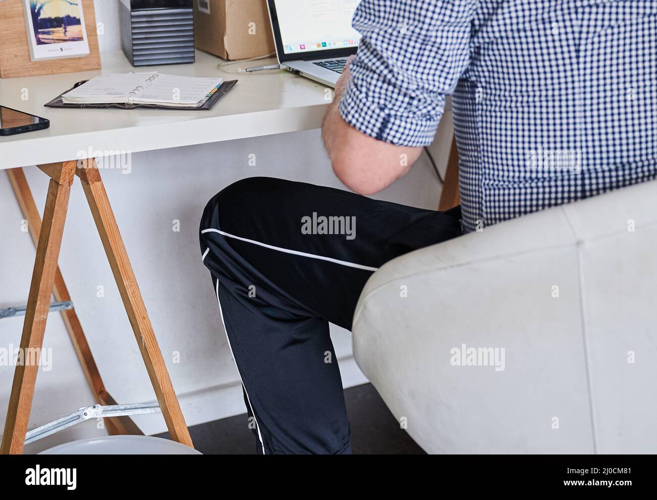 ILLUSTRATION - 06 March 2022, Berlin: A man sits at a desk at home ...