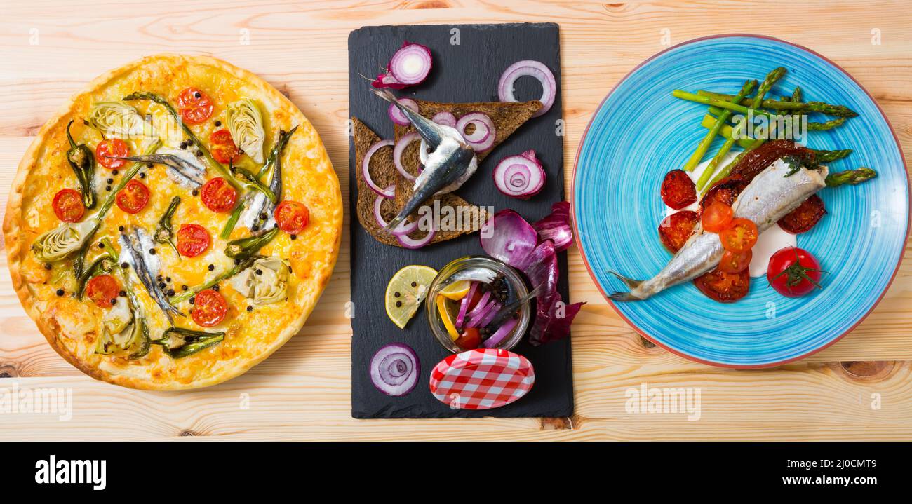 Set of dishes with small sea fish Stock Photo - Alamy