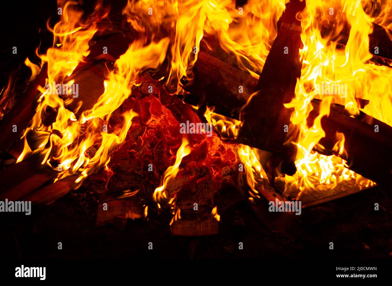 Bonfire burning hot with yellow flames Stock Photo - Alamy
