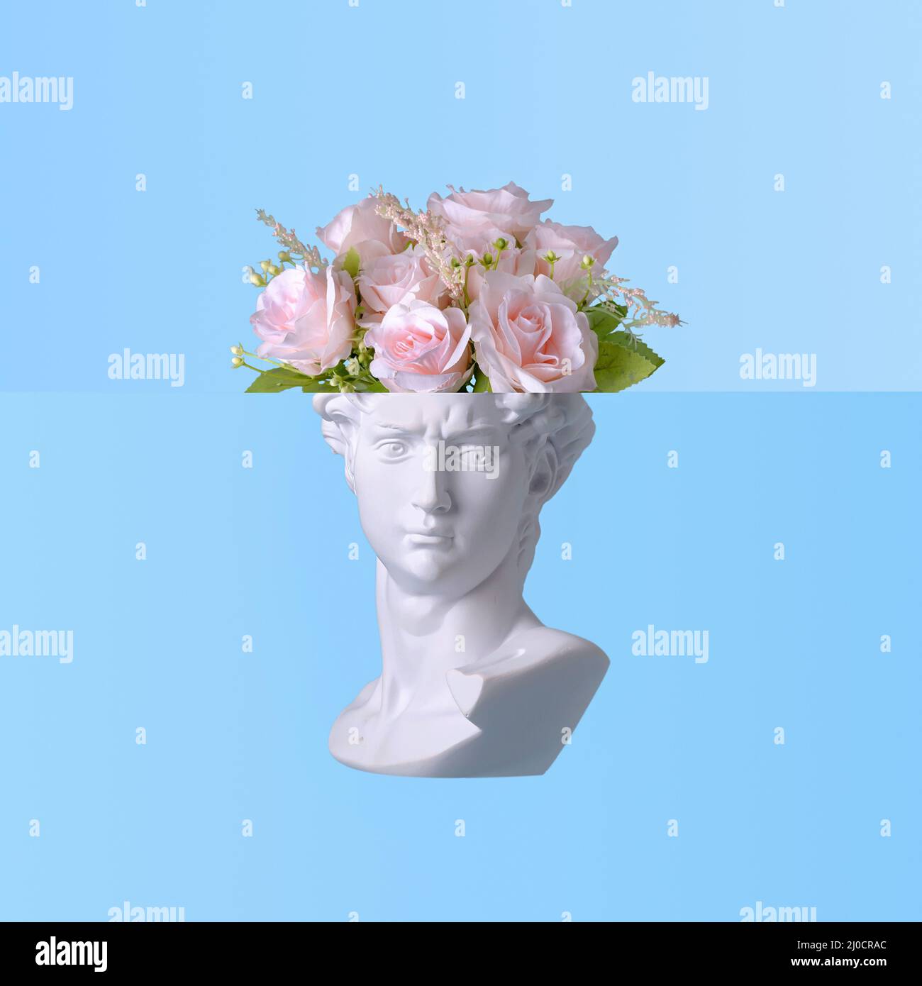 White Roman bust with pink roses inserted in a composite image over ...
