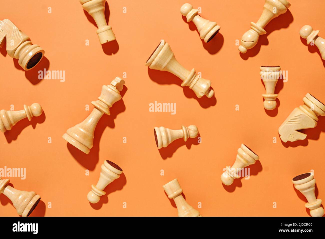 White chess pieces pattern on an orange background. Minimal concept of ...