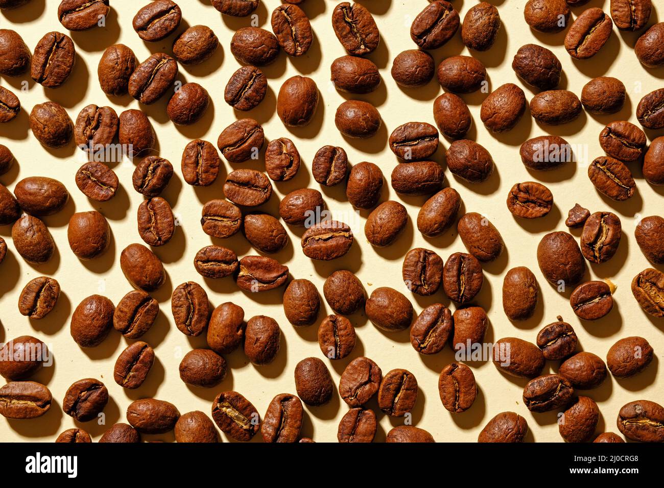 Background texture of full roast whole coffee beans scattered over a ...