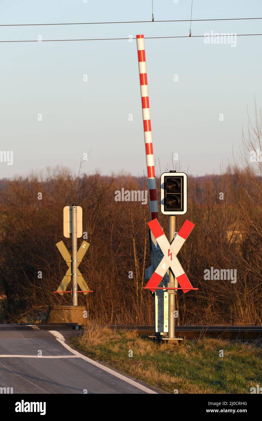 Open railroad crossing with a barrier and a traffic light, transport ...