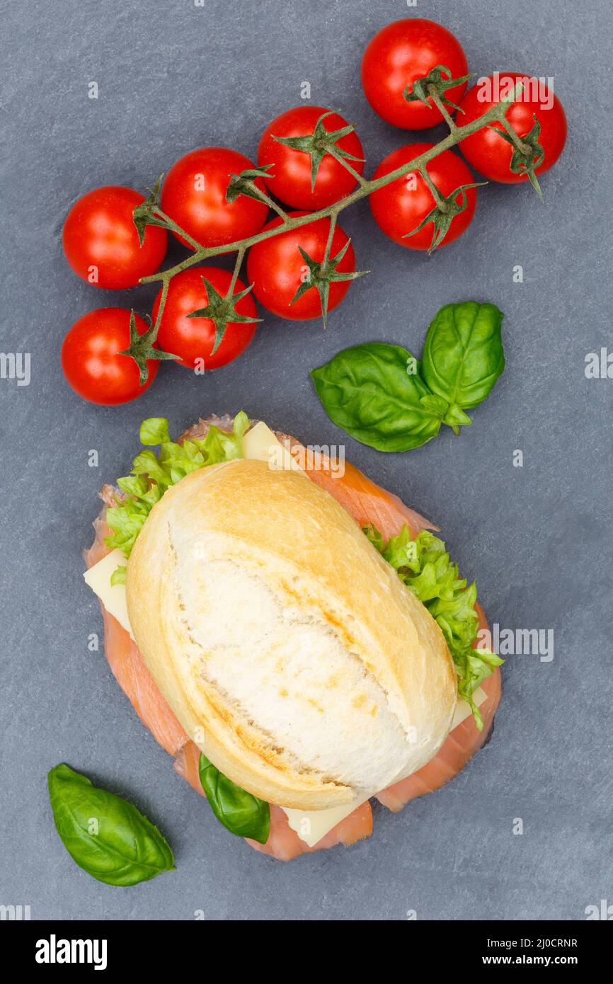 Roll sandwich baguette topped with fish salmon portrait from above ...