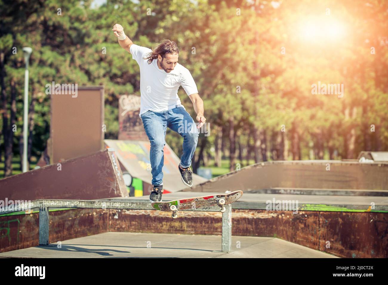 Action shot of a skateboarder skating at the skate park with concrete ...