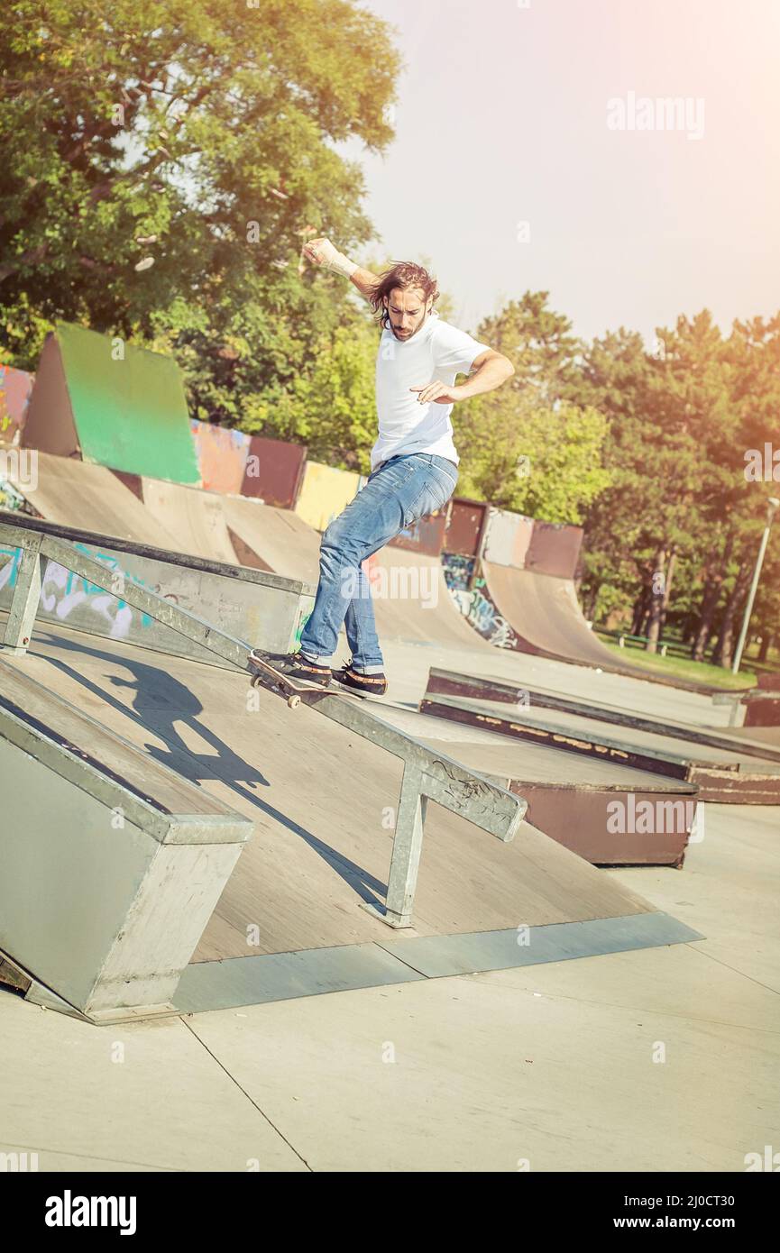 Action shot of a skateboarder skating at the skate park with concrete ...