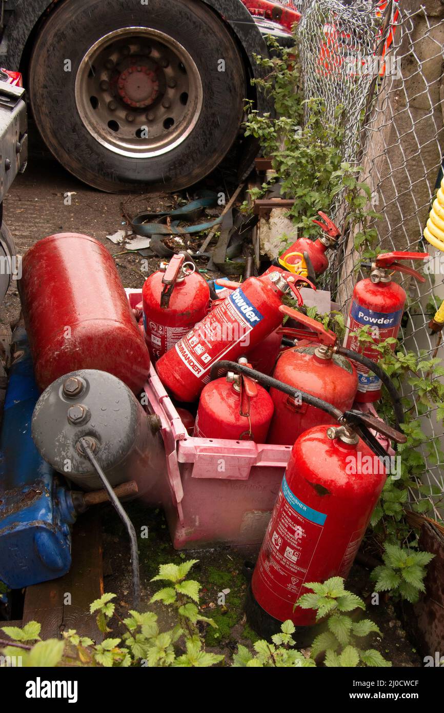 Vertical shot of many red fire extinguishers in a box at a truck lorry ...