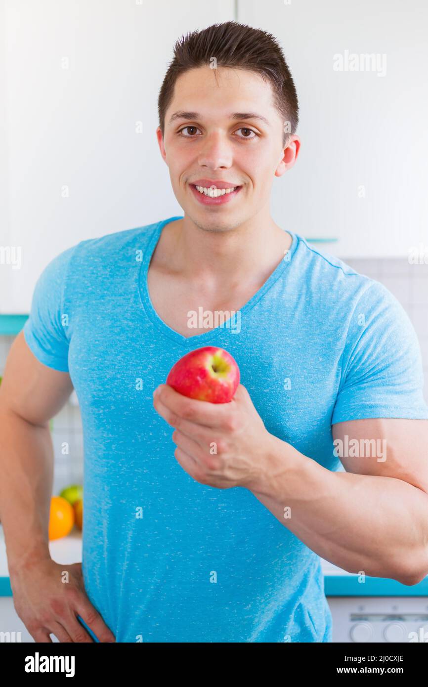 Healthy diet young man food apple fruit fruit in the kitchen portrait ...