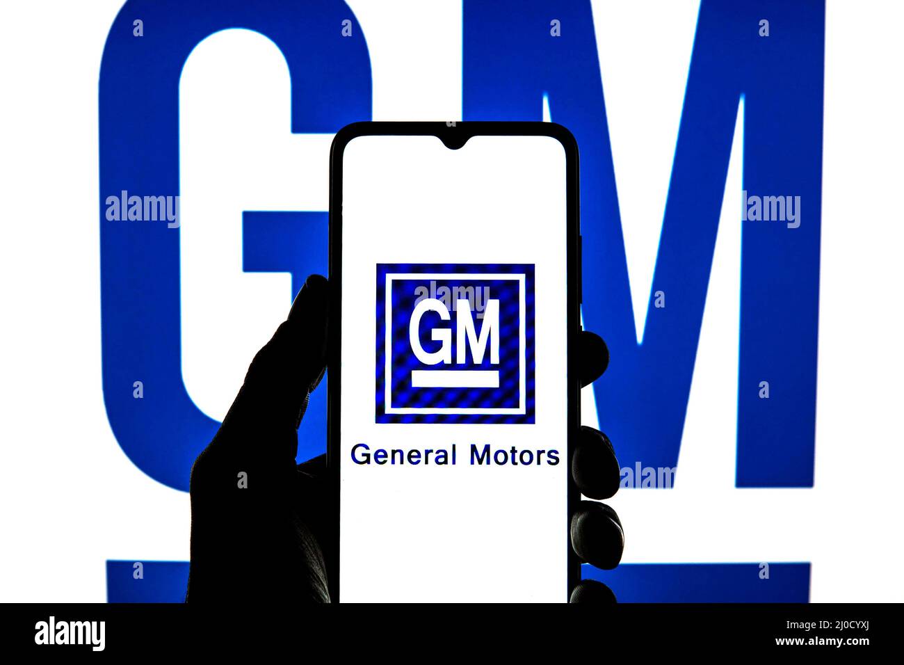 In this photo illustration a General Motors Company logo seen displayed ...