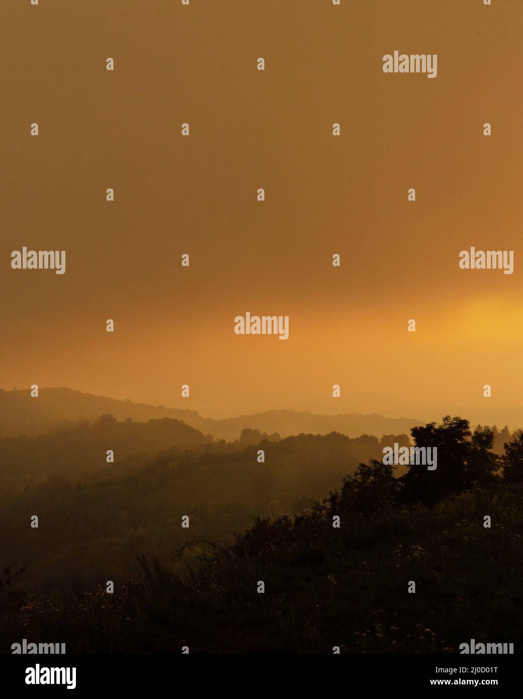 Vertical shot of a scenic sunset over the town Stock Photo - Alamy