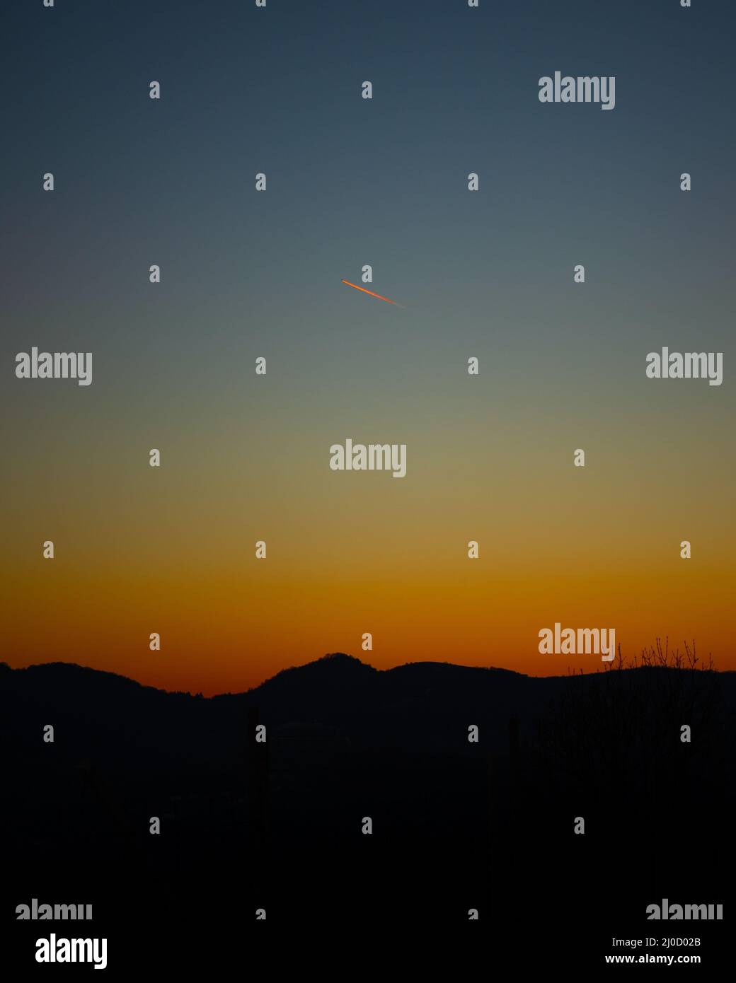 Vertical shot of a scenic sunset over the town Stock Photo - Alamy