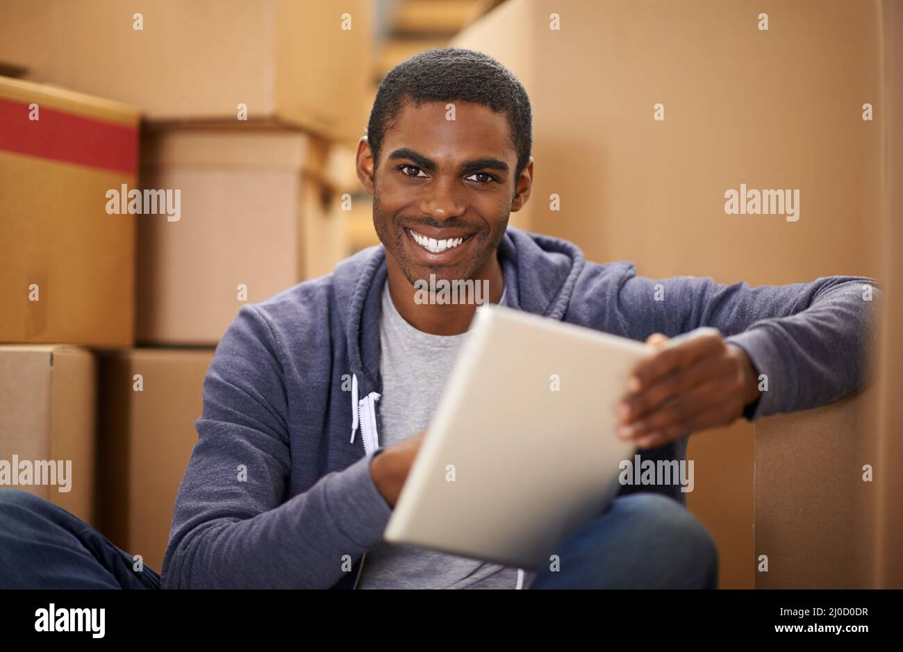 Hes moving house. A handsome young man packing boxes Stock Photo - Alamy