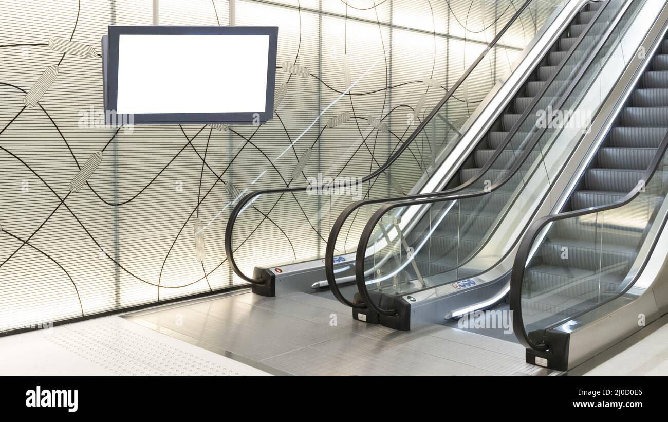 Blank digital display on the wall with a white screen next to an ...