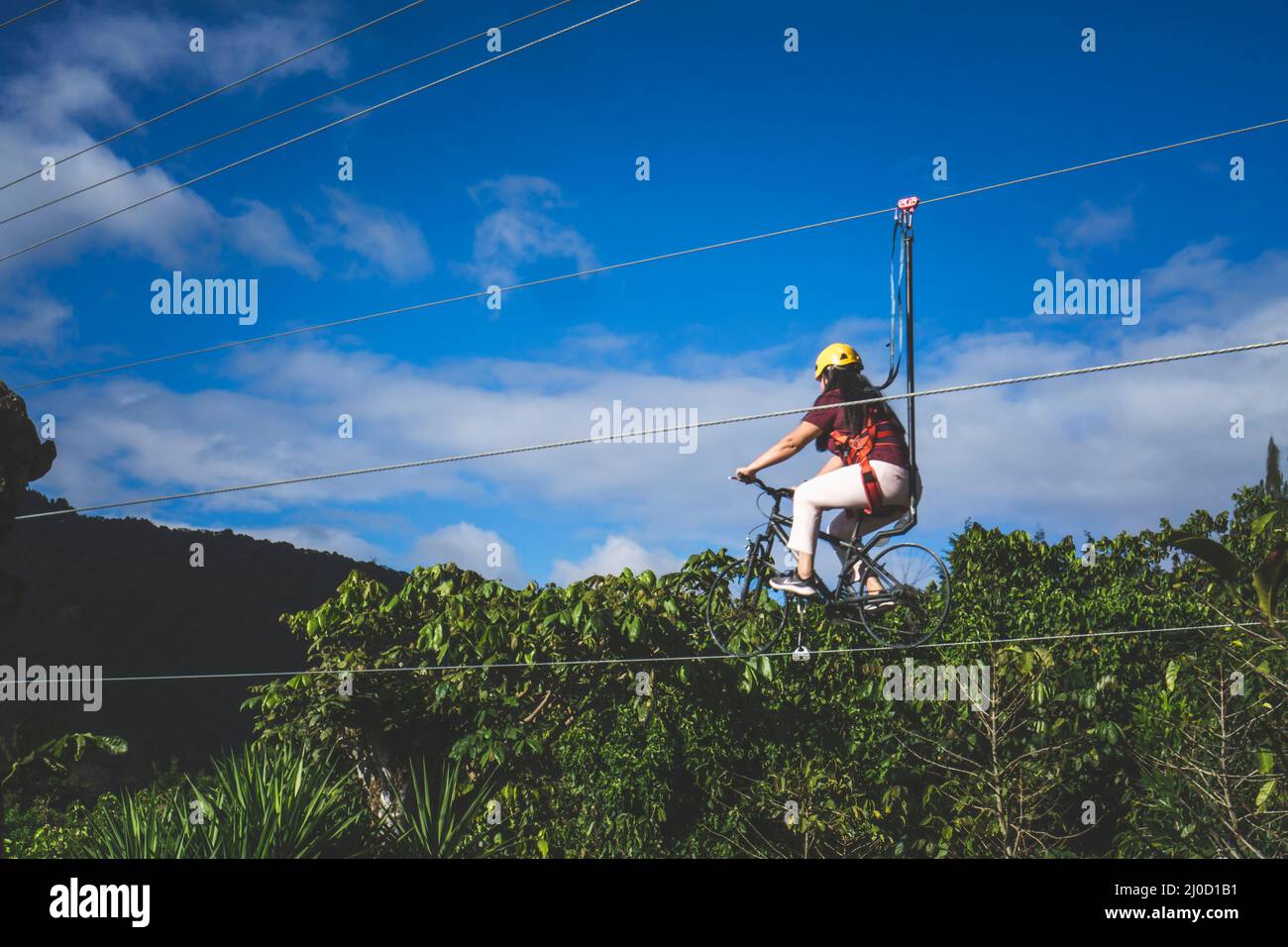 Riding a bike on a zip line on a nice day in El Salvador. Cycling ...