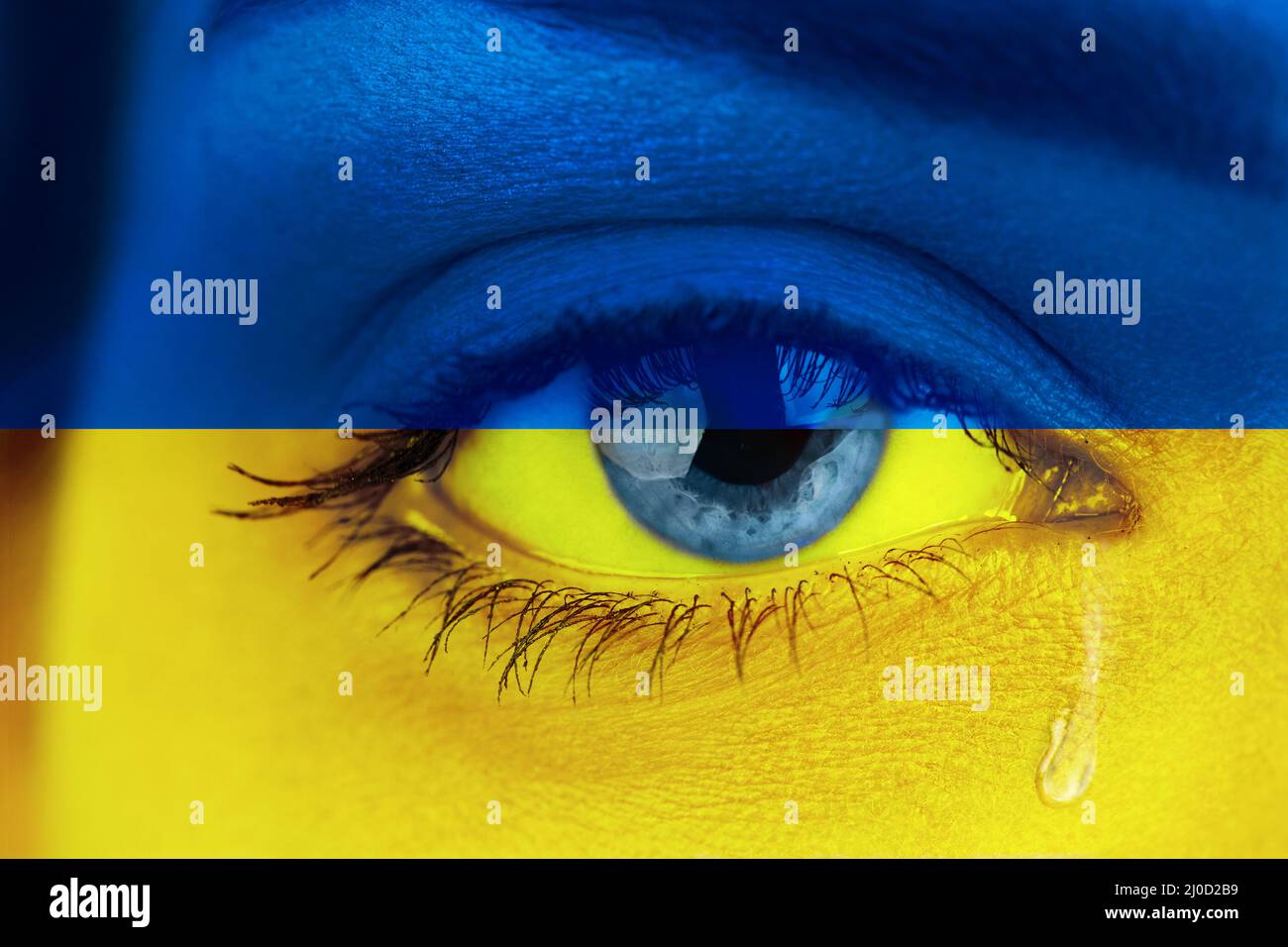 Eye, crying with a tear running down her cheek. Ukraine flag painted ...