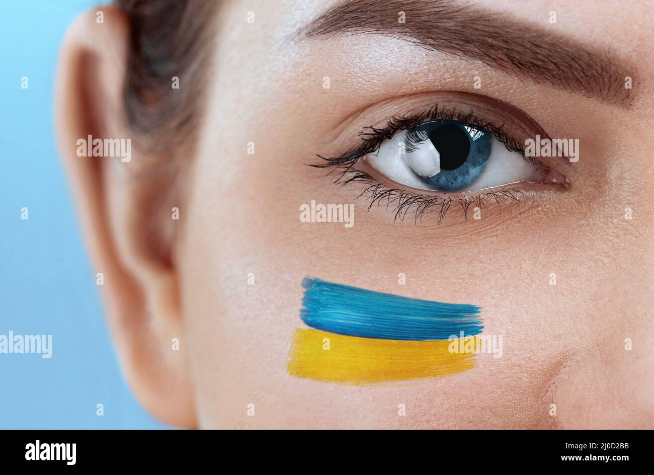 Ukraine flag painted over female face. ukraine crisis concept Stock ...