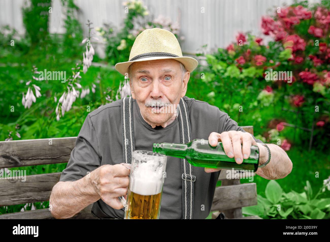 old man with a glass and a bottle of foamy beer Stock Photo - Alamy