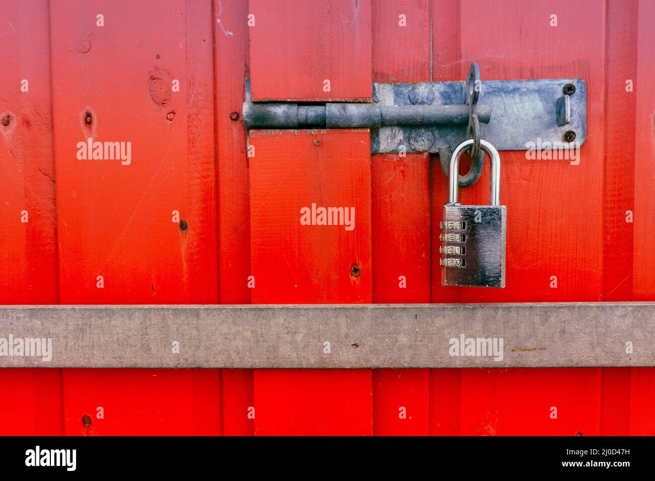 Padlock on a red door Stock Photo - Alamy