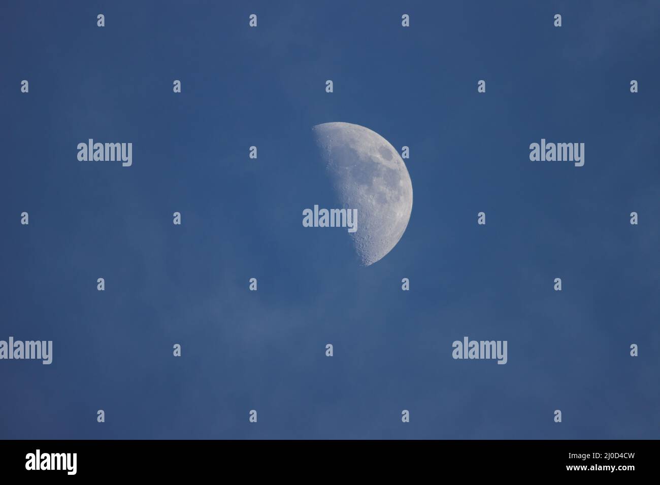 a close up of the crescent moon in the daytime with blue sky Stock ...