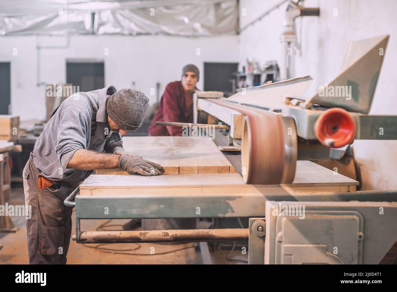 Carpenter sanding a wood with belt sander Stock Photo - Alamy