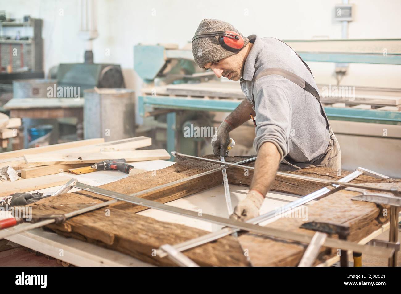 Construction Worker Using Tape Measure. Professional carpenter at work ...
